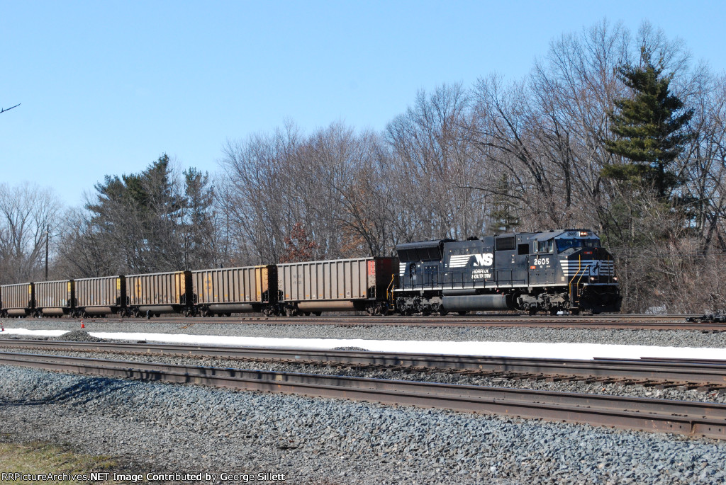 A lone unit takes an empty coal train east.